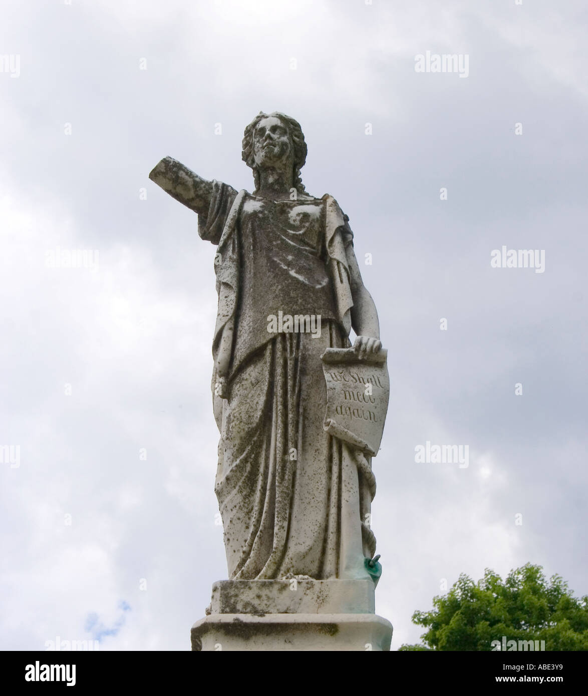 One armed statue holding the message We Shall Meet Again at a grave in ...