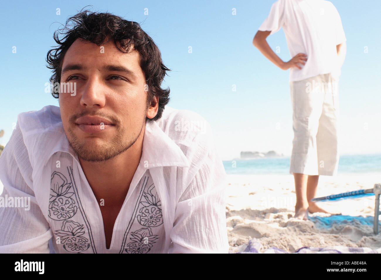 Man lying on the beach Stock Photo - Alamy