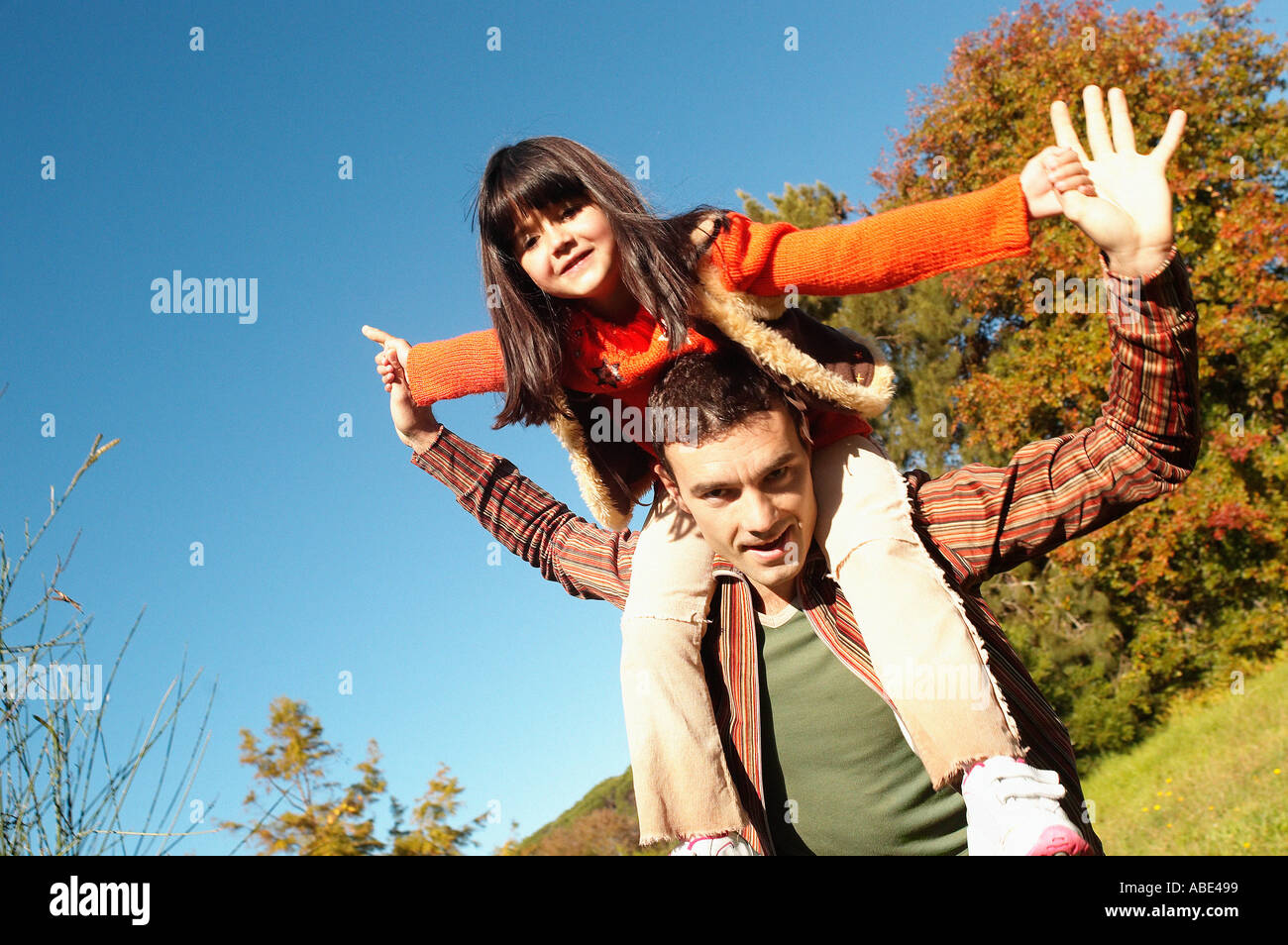 Father shoulder carrying daughter Stock Photo - Alamy