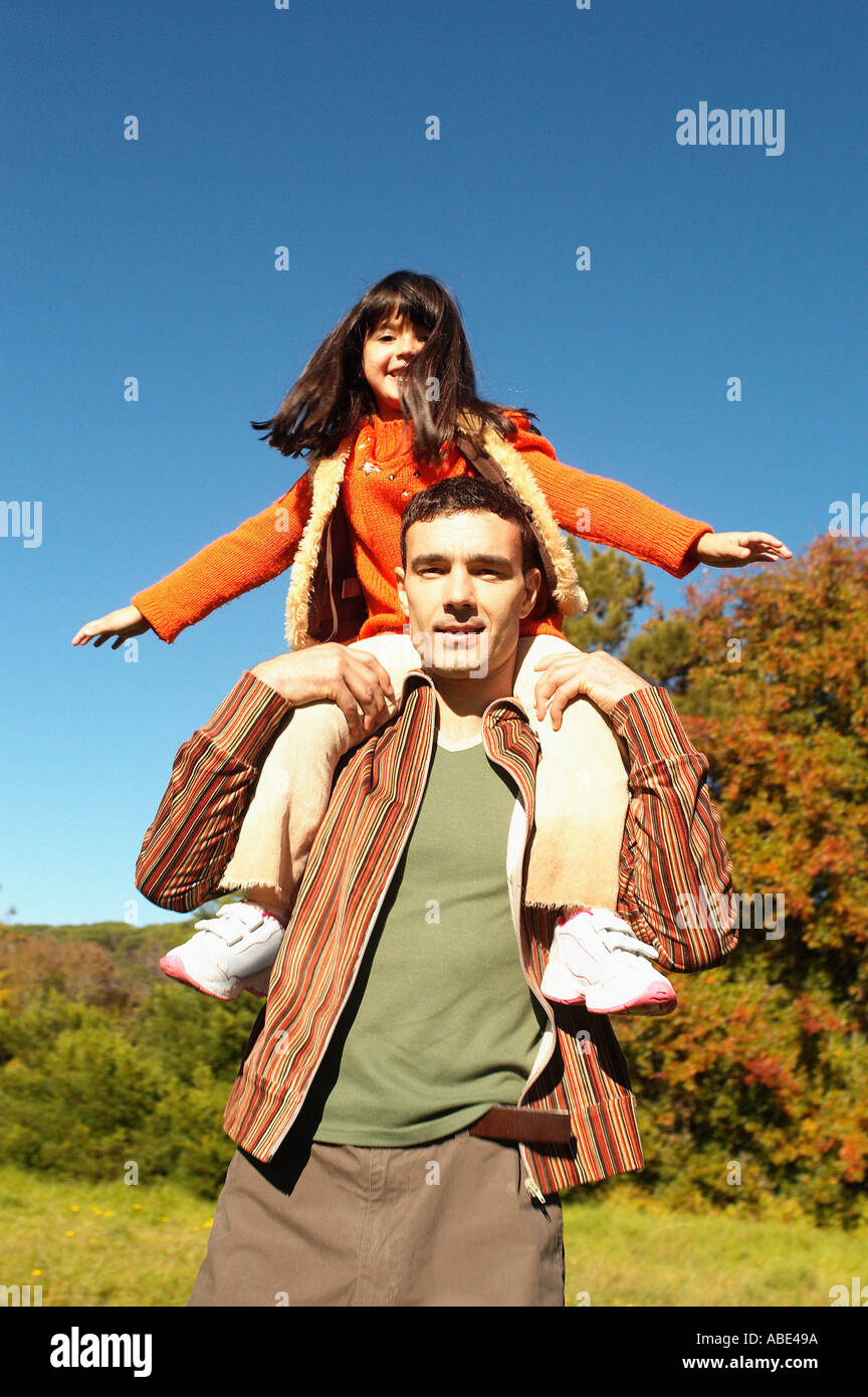 Father shoulder carrying daughter Stock Photo - Alamy