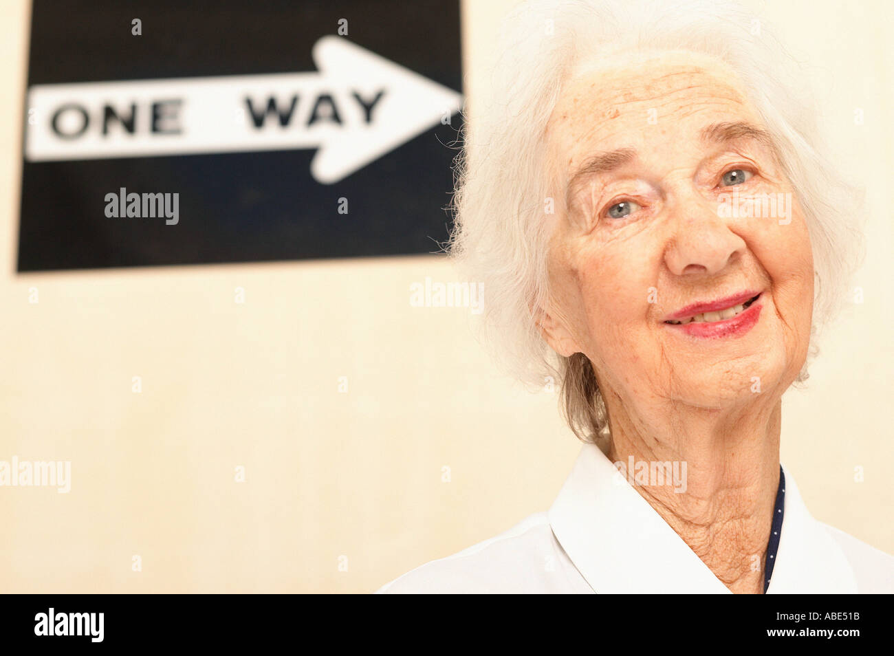 Elderly woman with one way sign Stock Photo - Alamy