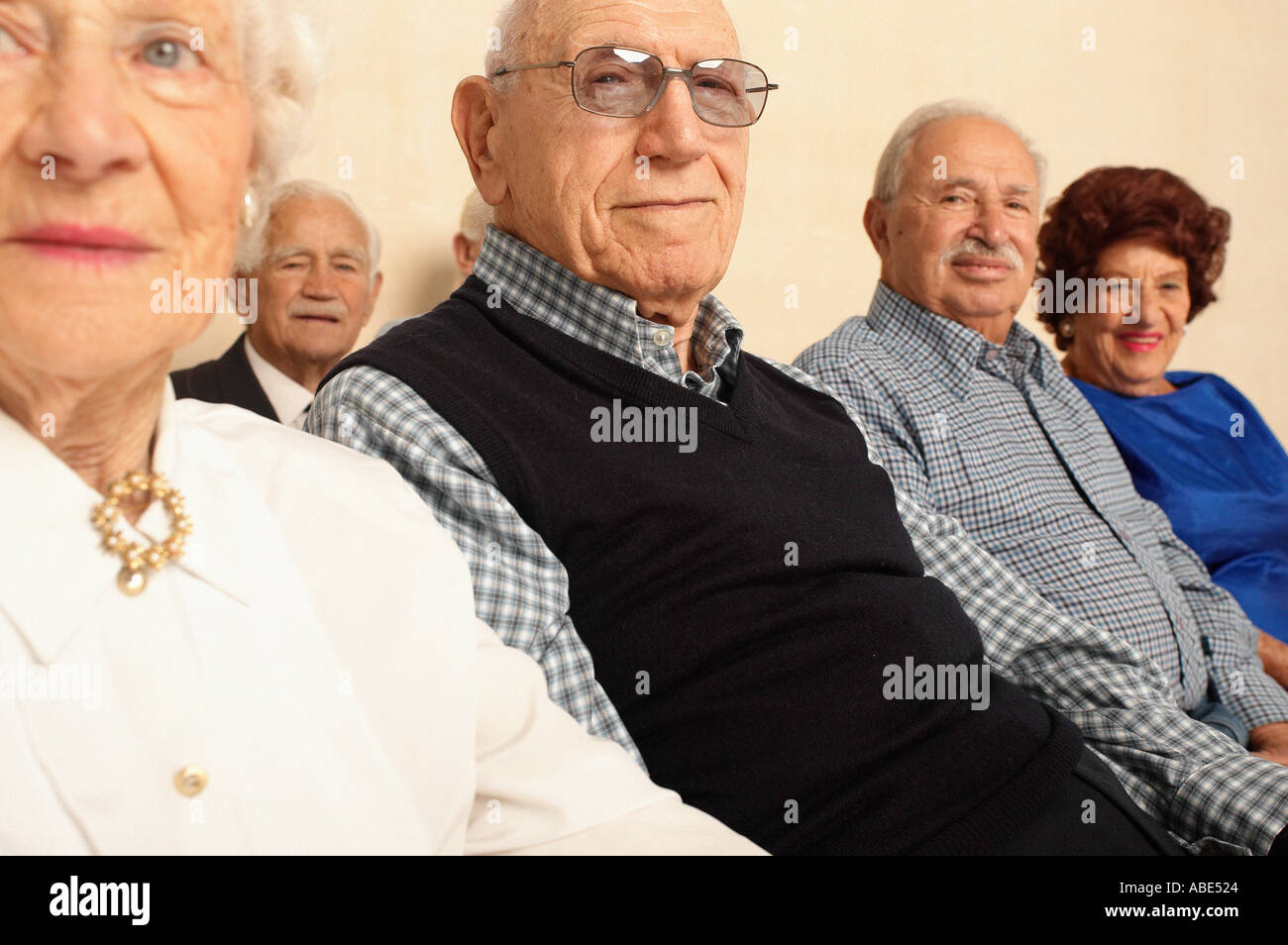 Elderly people seated facing camera Stock Photo - Alamy