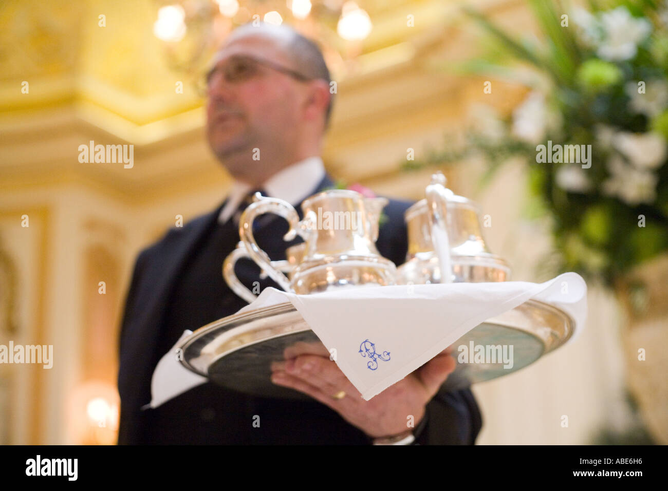 A waiter serves tea in the Palm Court at the Ritz Hotel London Stock ...