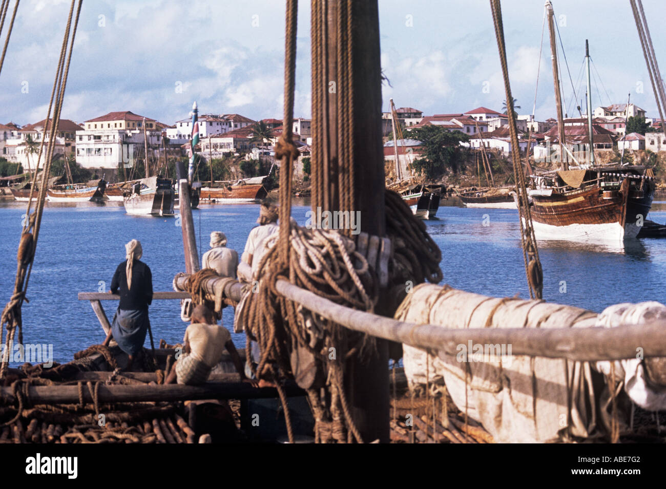 An Arab dhow--an oceangoing boom--motors slowly into Mombasa's Old Port ...