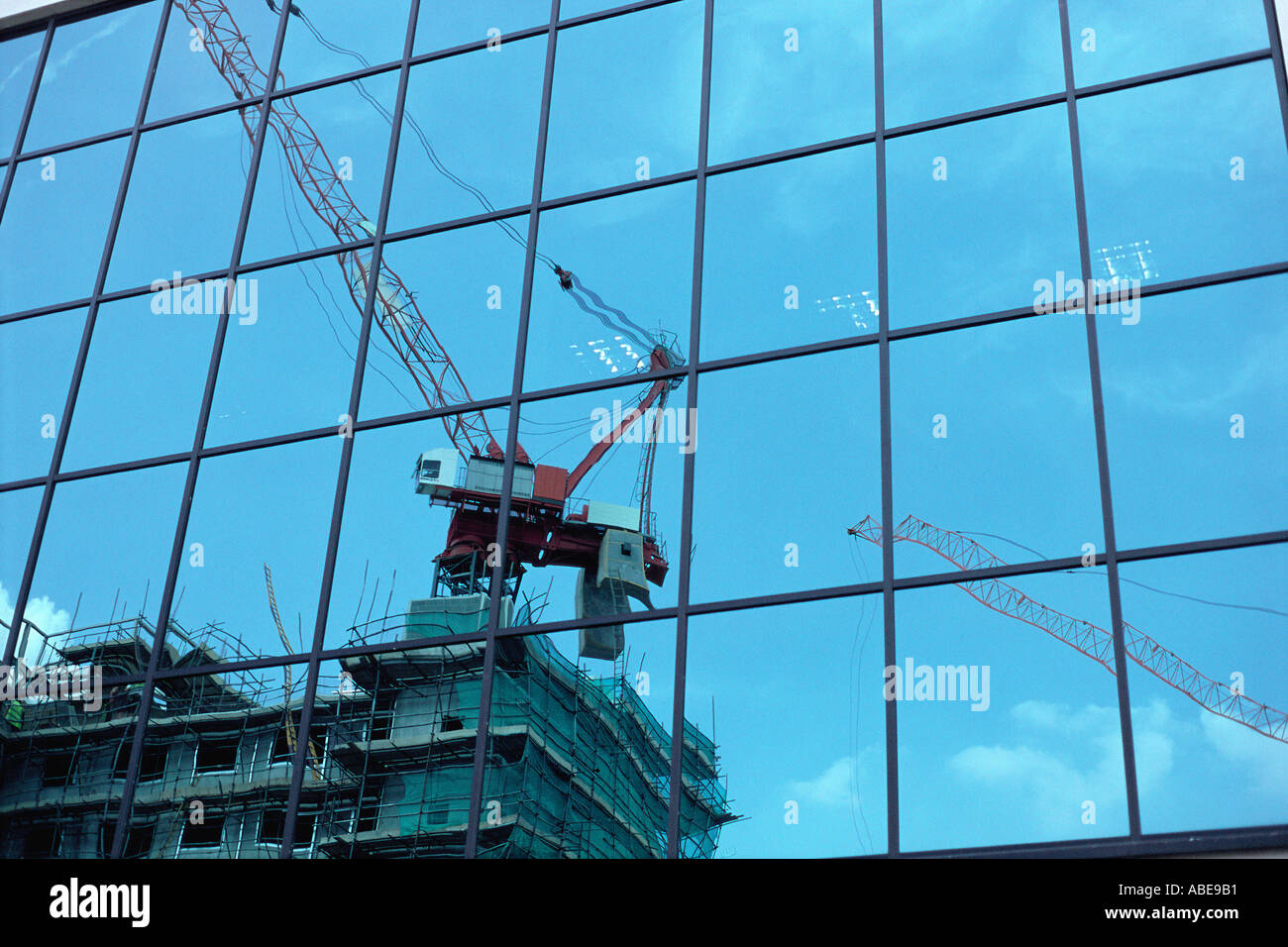 Reflection of construction crane on glass Stock Photo - Alamy