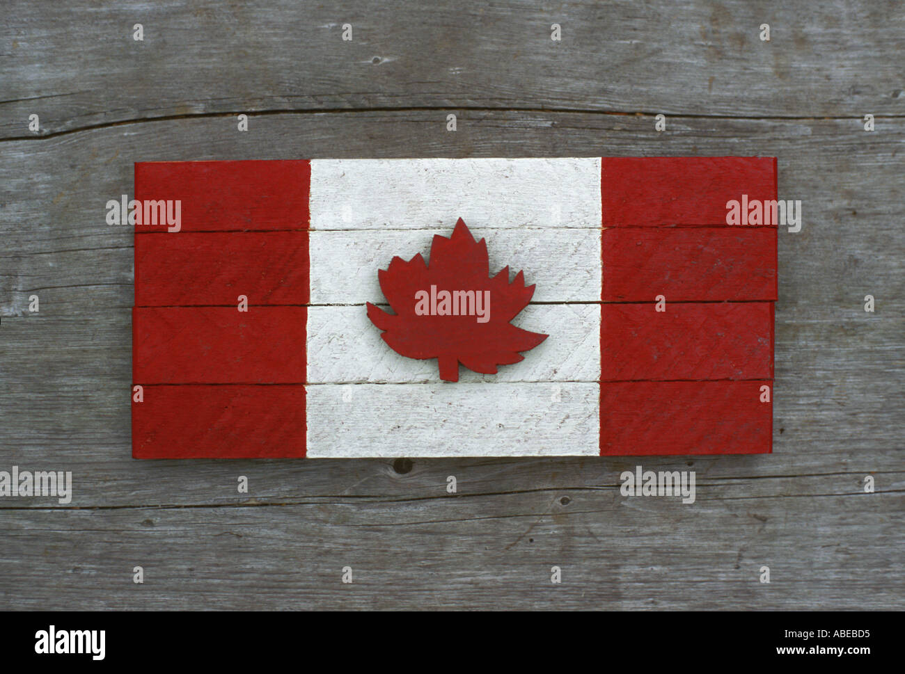 A rustic red and white painted wooden Canadian flag with a cut out ...