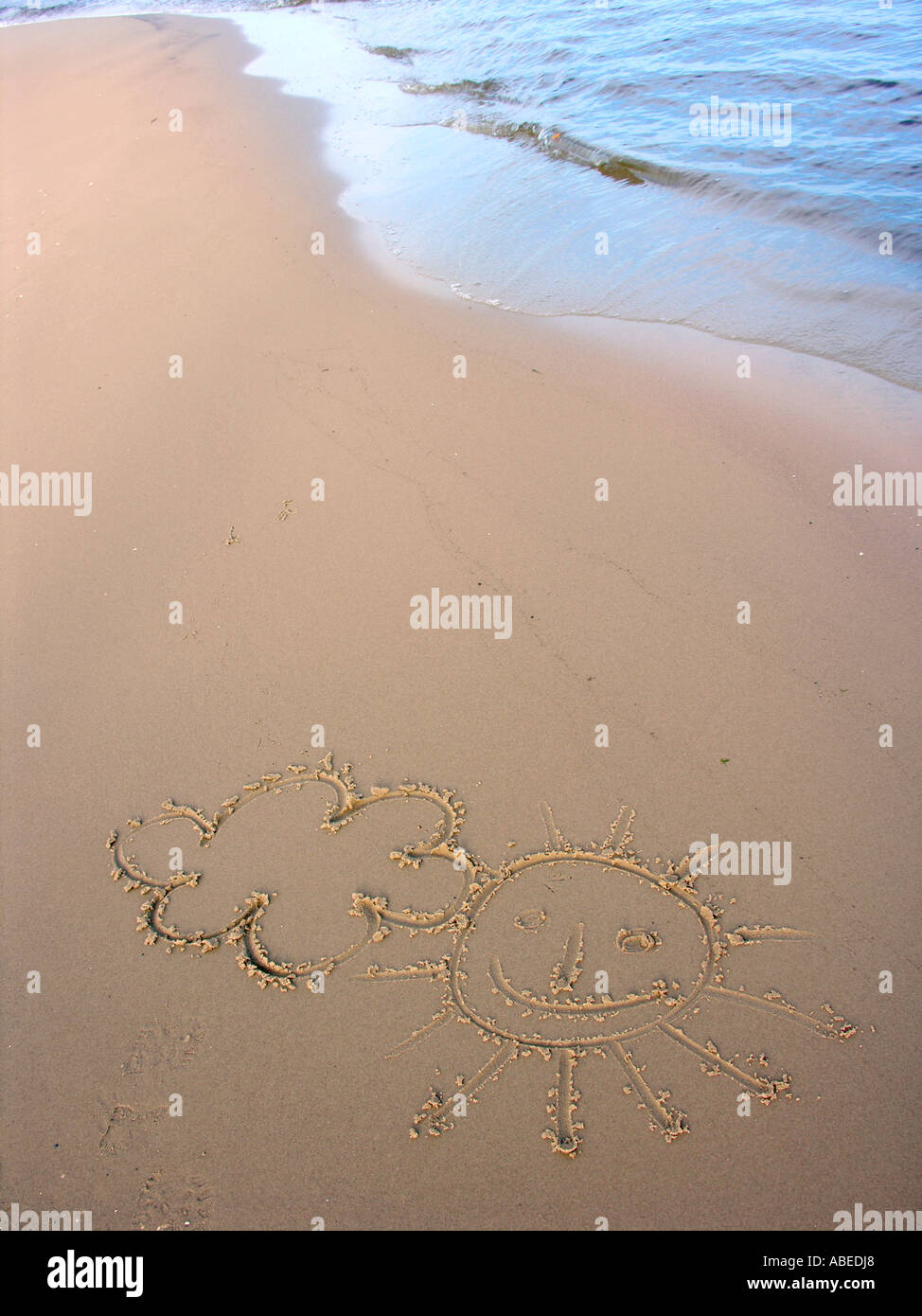picture drawing of sun and cloud on sand on a beach near to water Stock ...