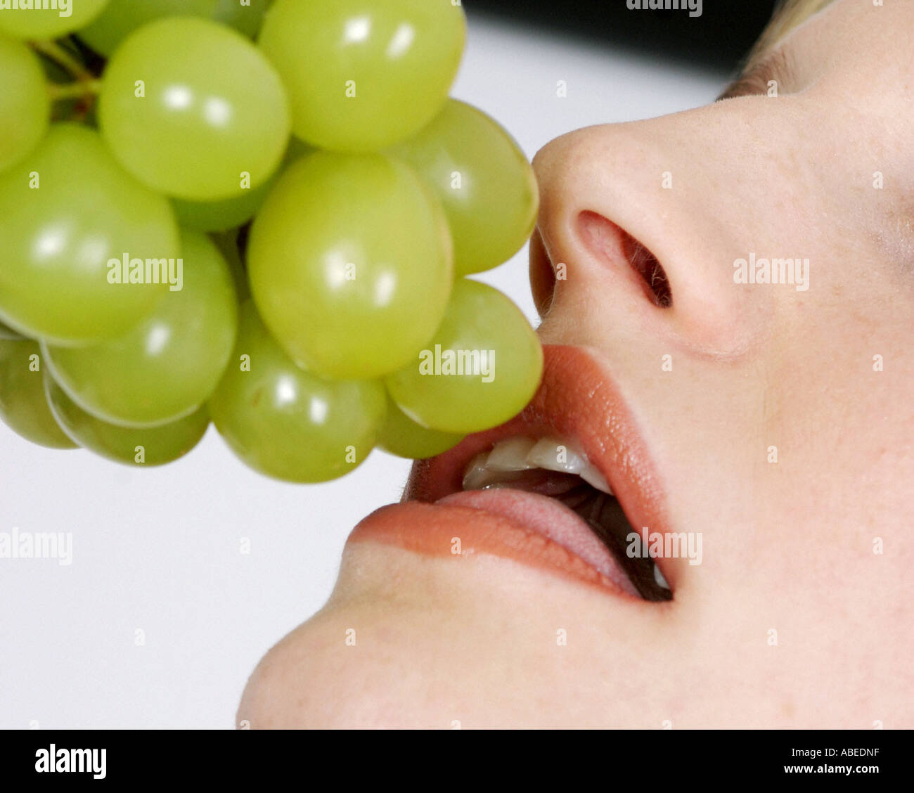 woman eating grapes Stock Photo - Alamy