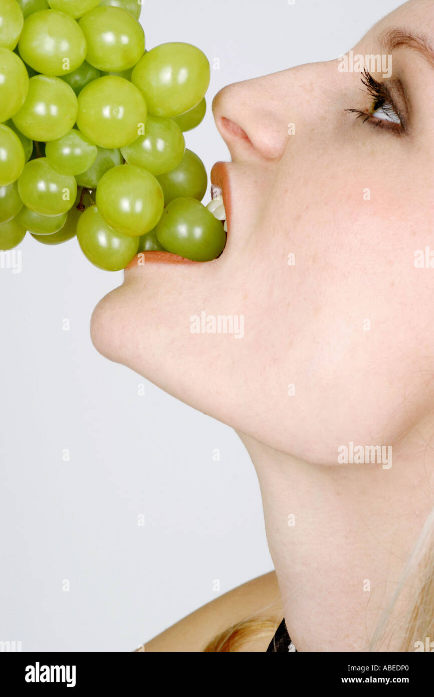 woman eating grapes Stock Photo - Alamy