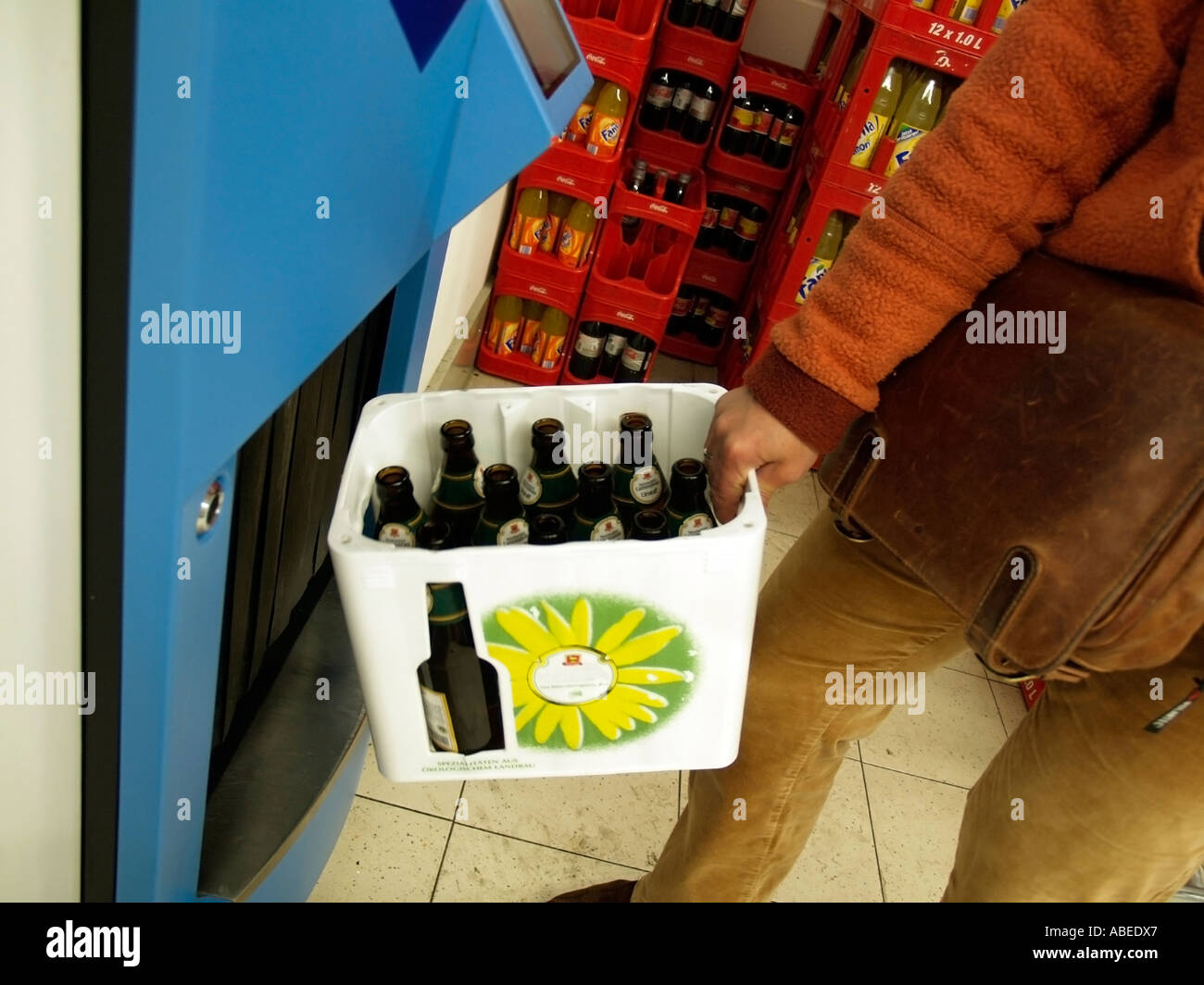 MR person bringing beer crate with deposit returnable bottles in ...