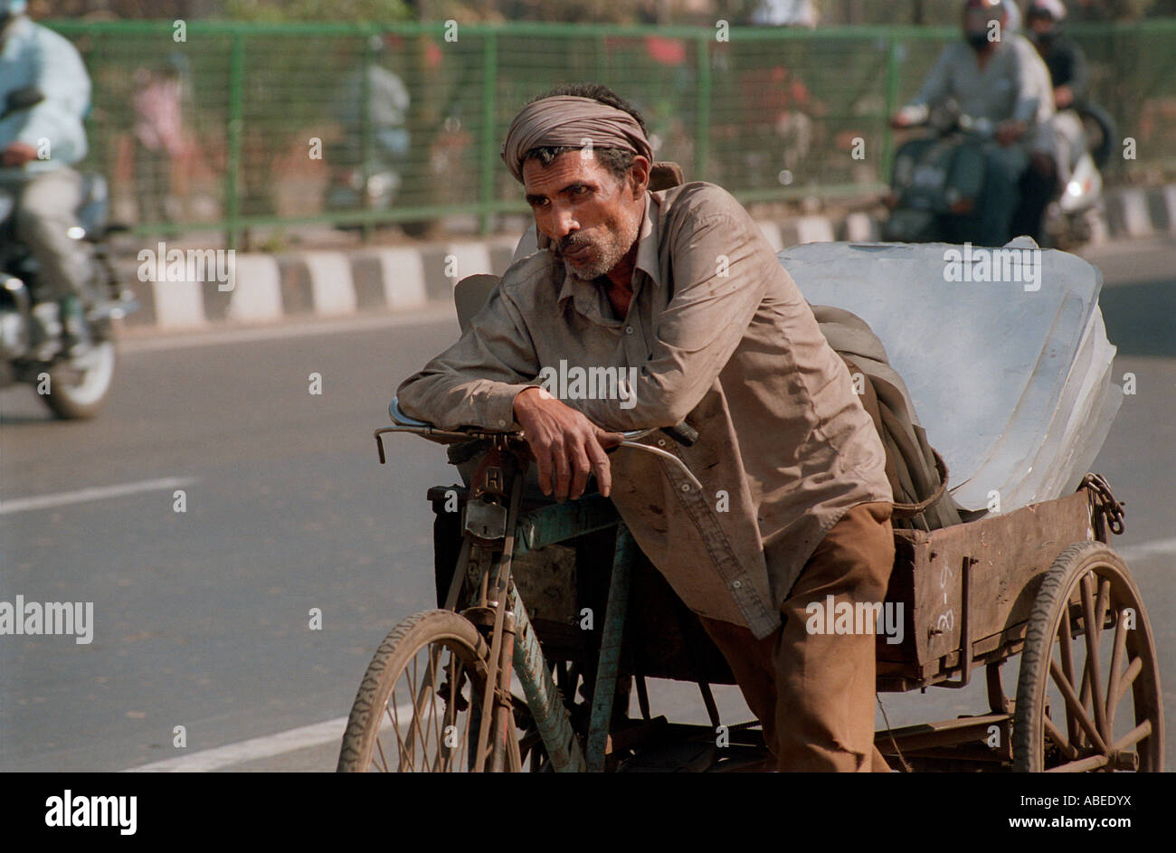 Indian man cycle pushing rickshaw Stock Photo - Alamy