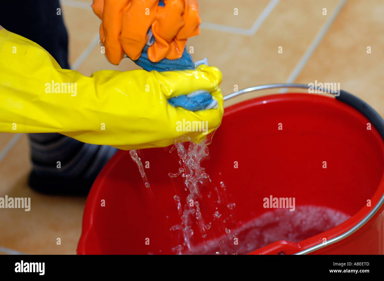 person housewife cleaning the floor hands wearing rubber gloves in ...
