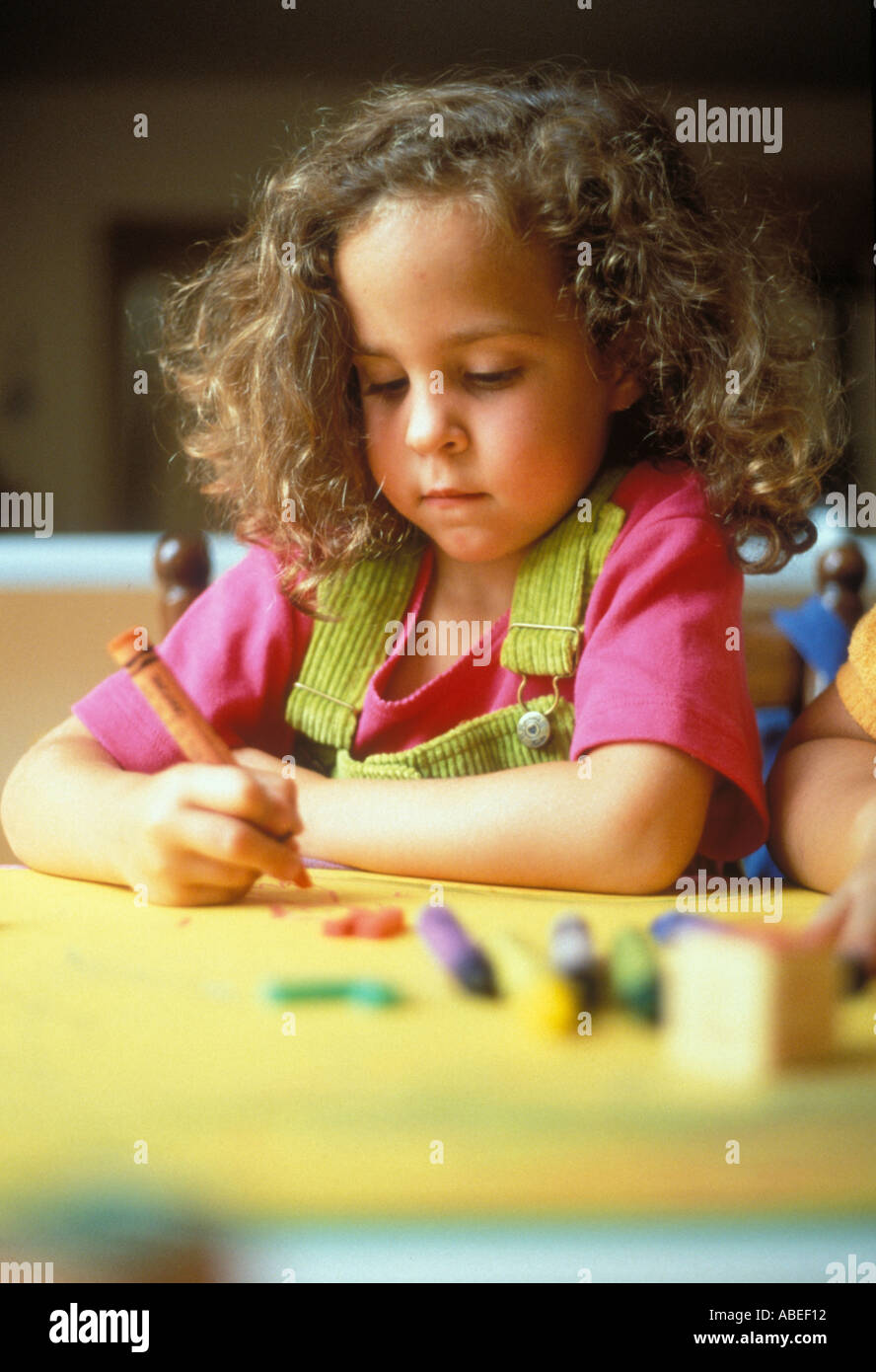 Young girl drawing with crayons Stock Photo - Alamy