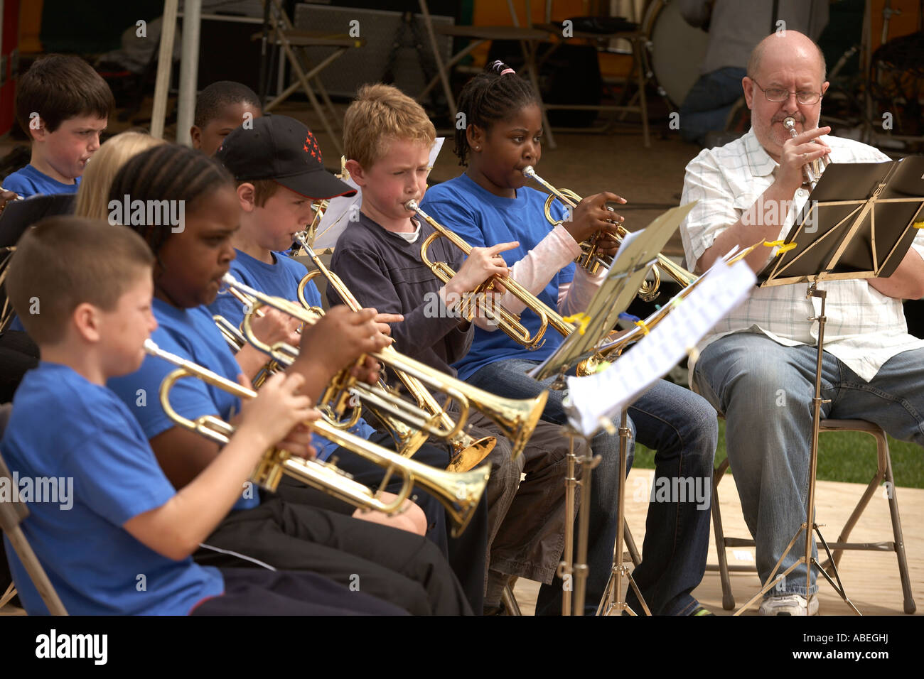 A youth ensemble brass orchestra plays in public at a summer fair in ...