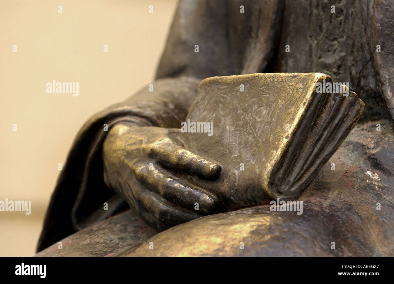 Hand of a statue with book Stock Photo - Alamy