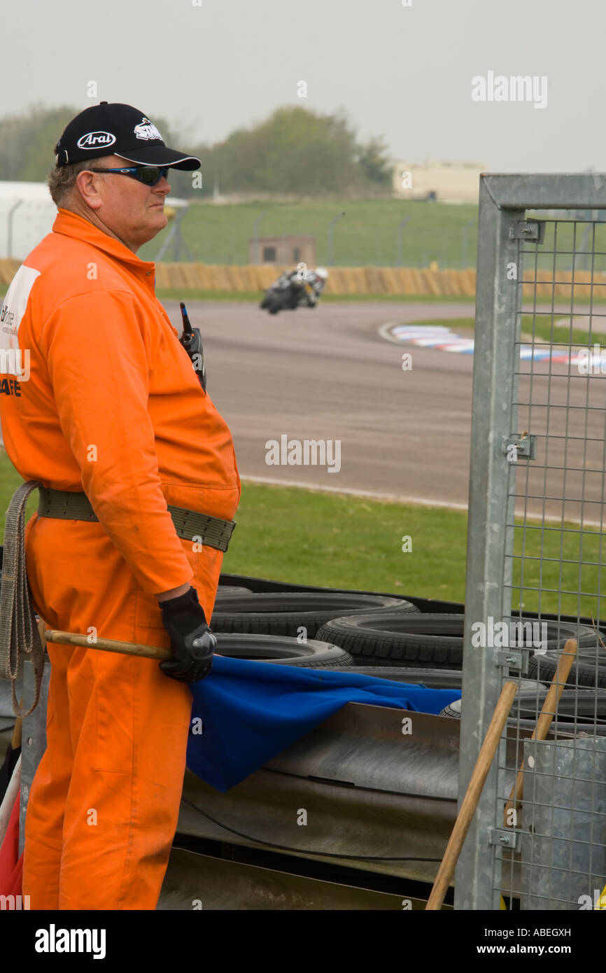 Safety marshal and coloured flags at race track Stock Photo - Alamy