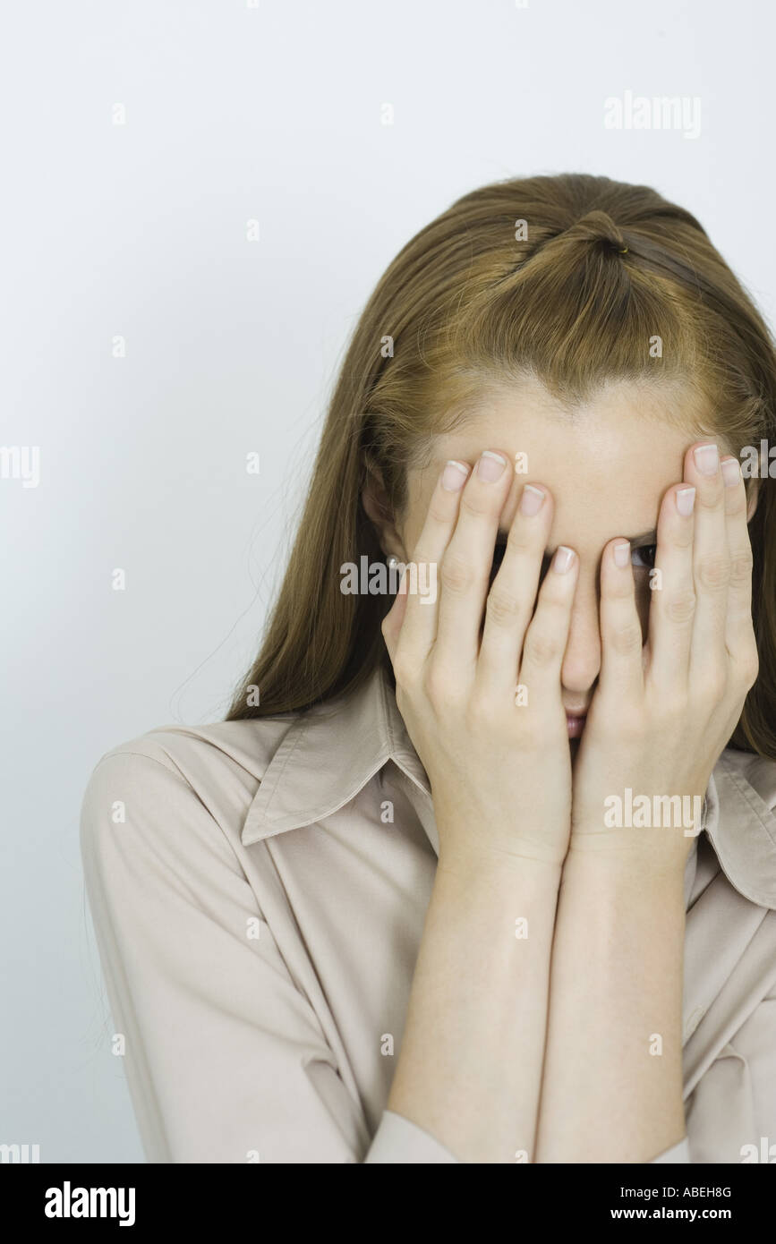 Teenage girl, hands over face, portrait Stock Photo - Alamy