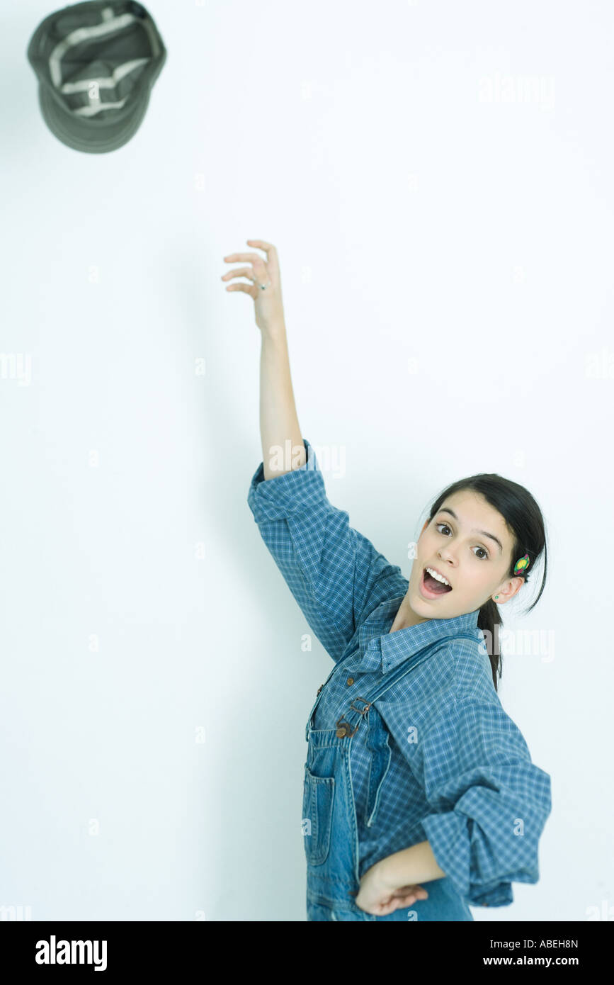Teenage girl throwing hat into air, portrait Stock Photo - Alamy