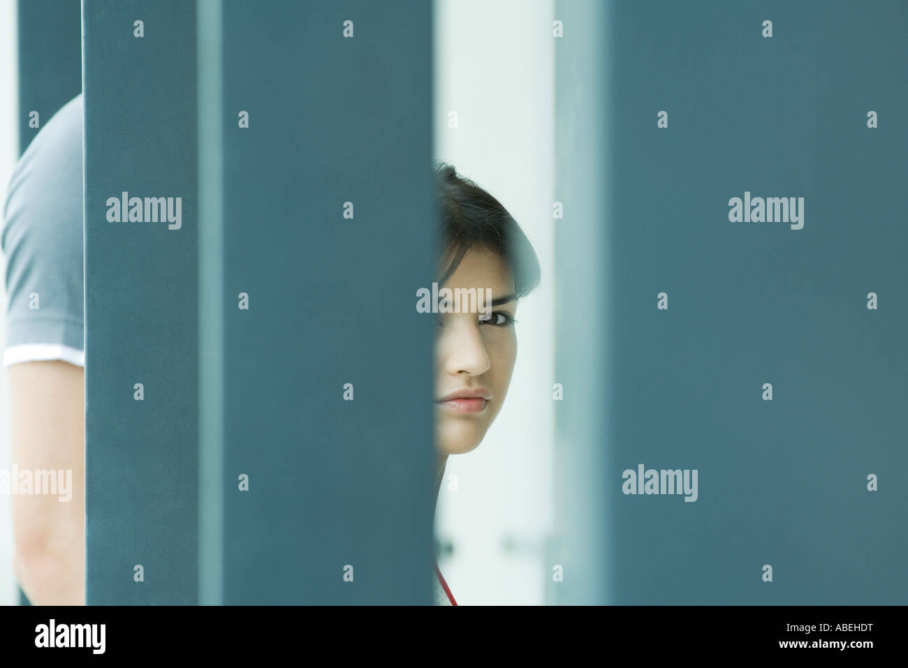 Young woman, seen through blurred foreground Stock Photo - Alamy