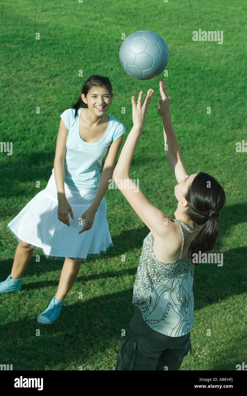 Two young female friends playing with soccer ball Stock Photo - Alamy