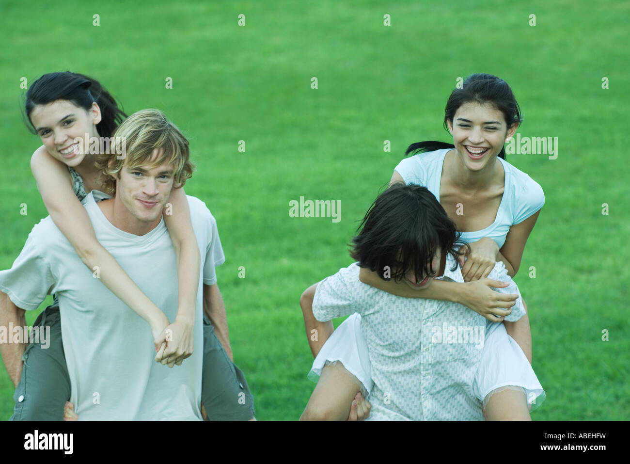 Group of young friends, riding piggyback Stock Photo - Alamy
