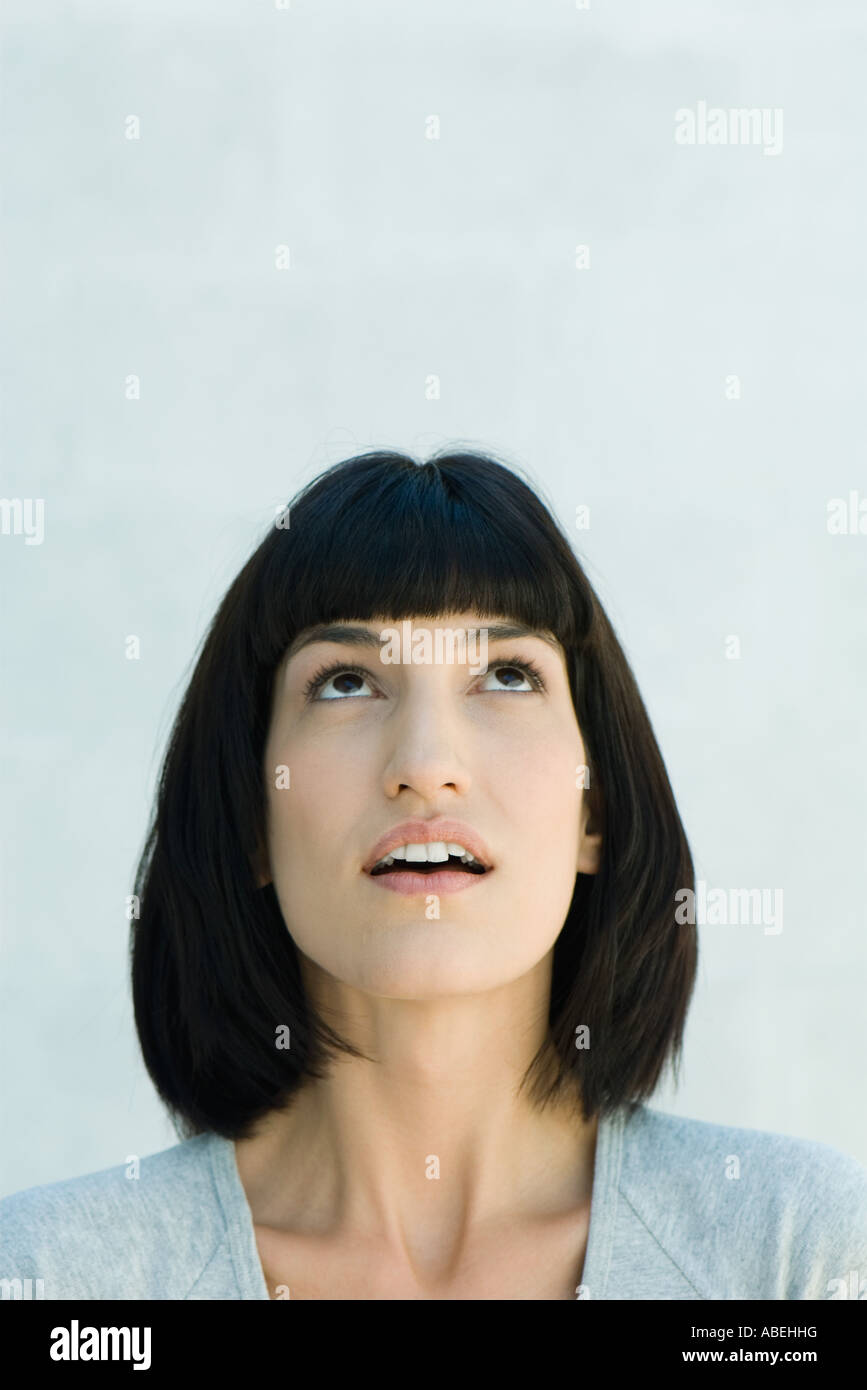 Woman looking up, head and shoulders, portrait Stock Photo - Alamy