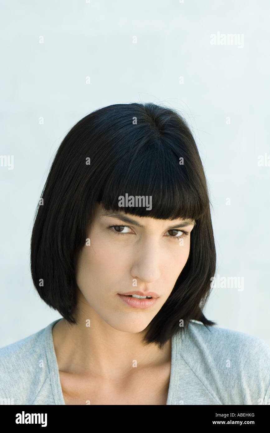 Woman scowling at camera, head and shoulders, portrait Stock Photo - Alamy