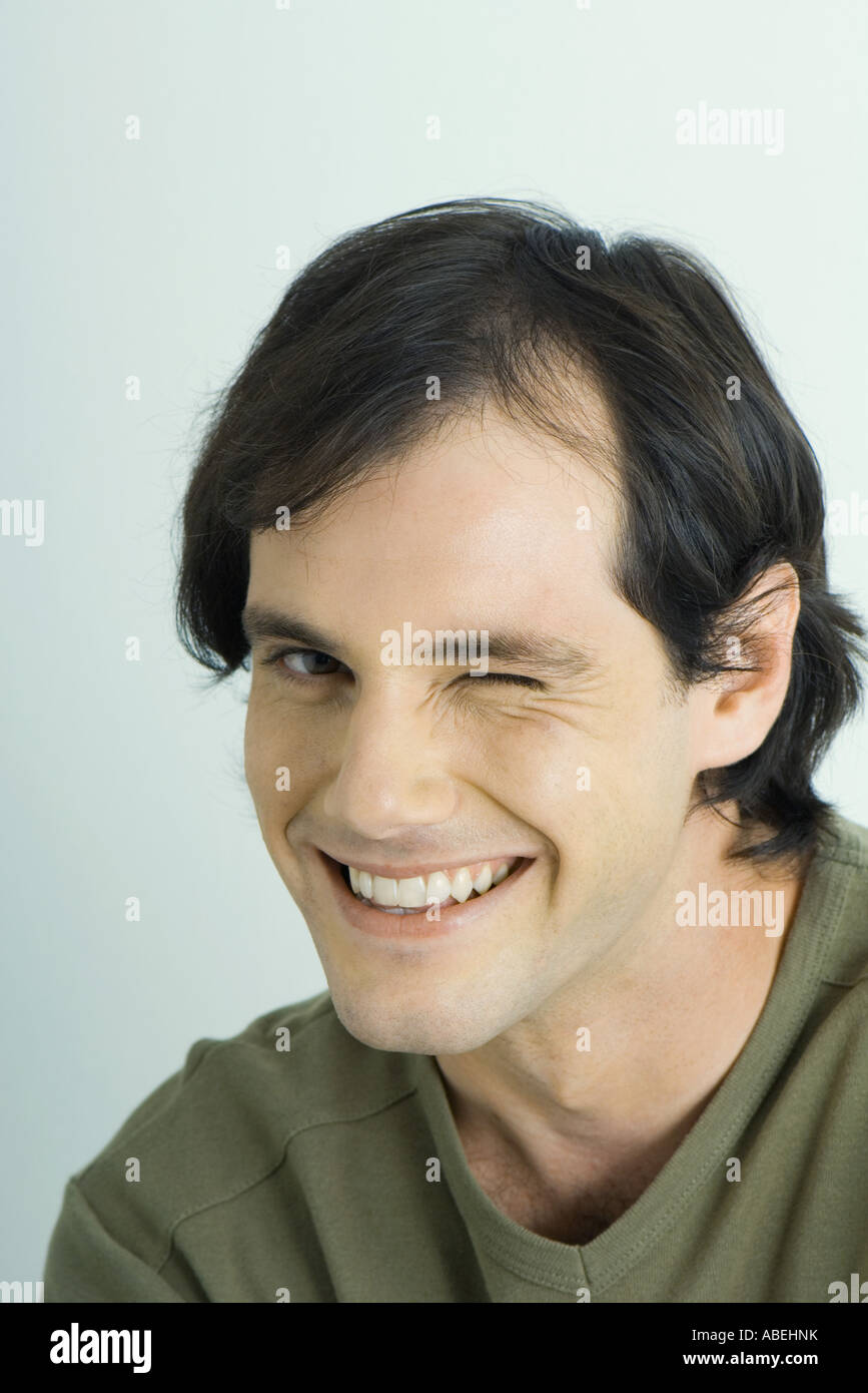 Man winking at camera, head and shoulders, portrait Stock Photo - Alamy