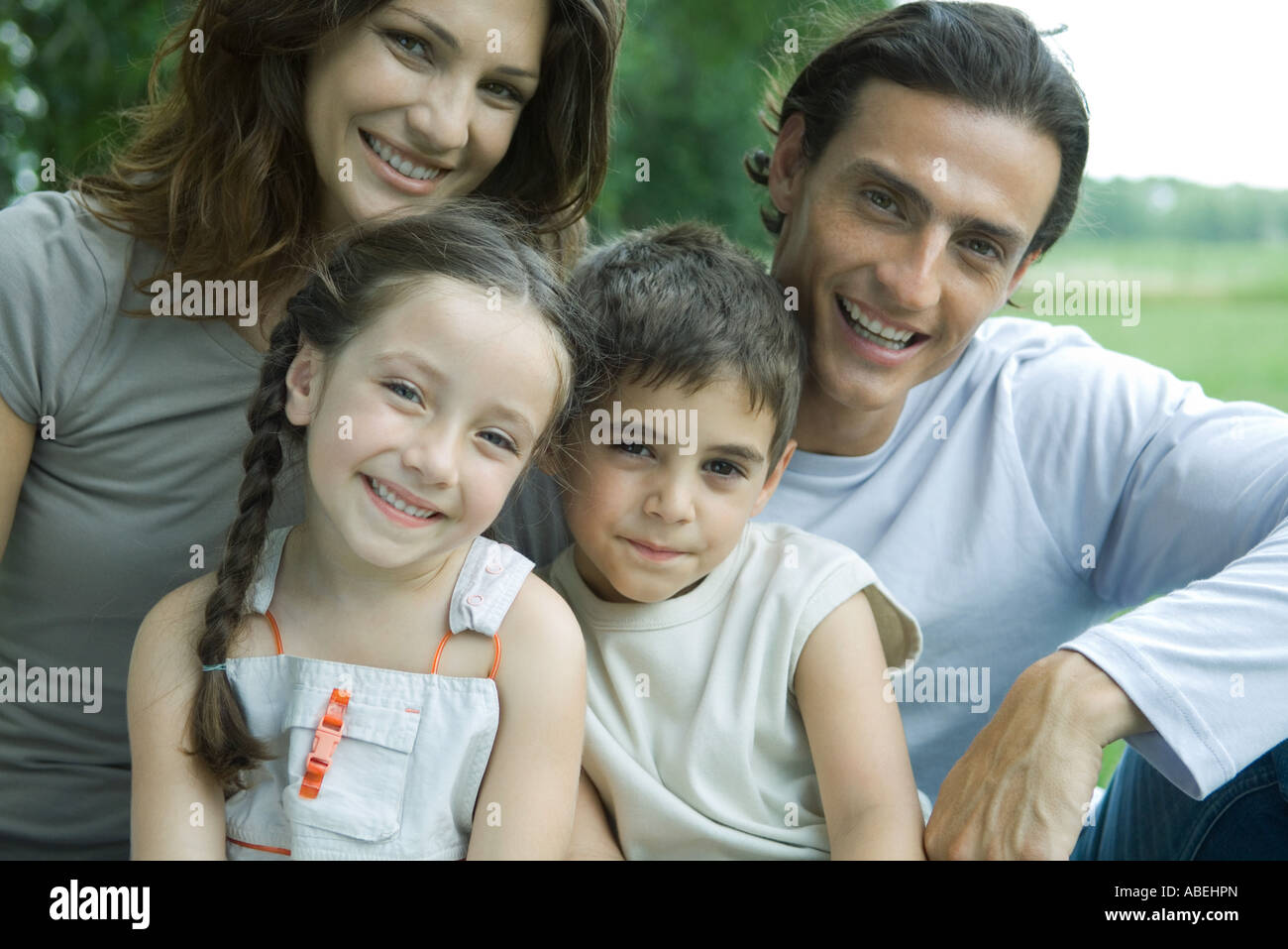 Family outdoors, smiling at camera, portrait Stock Photo - Alamy