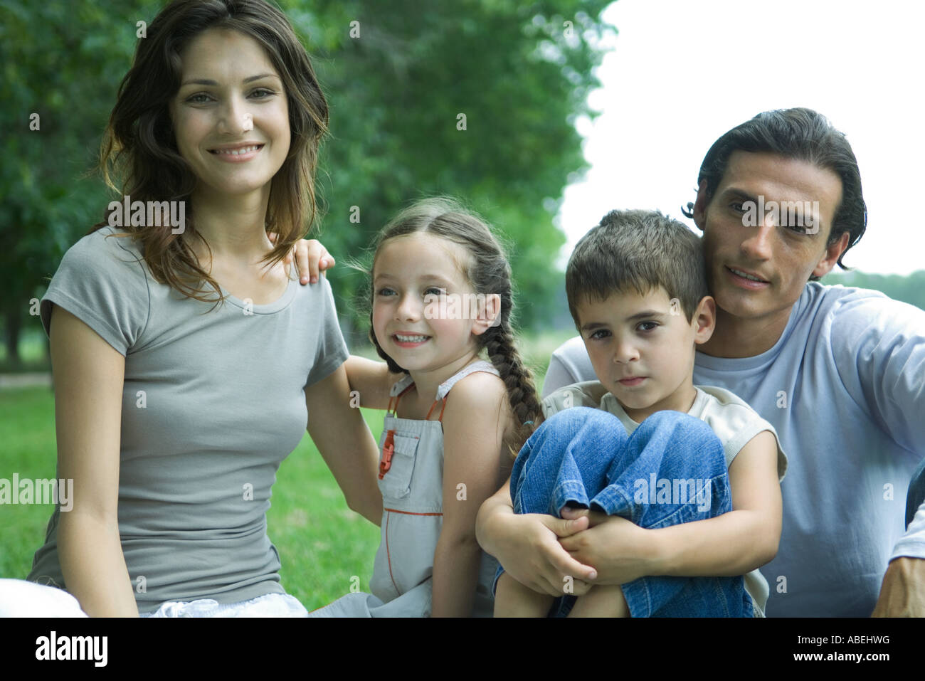 Family outdoors, smiling at camera, portrait Stock Photo - Alamy