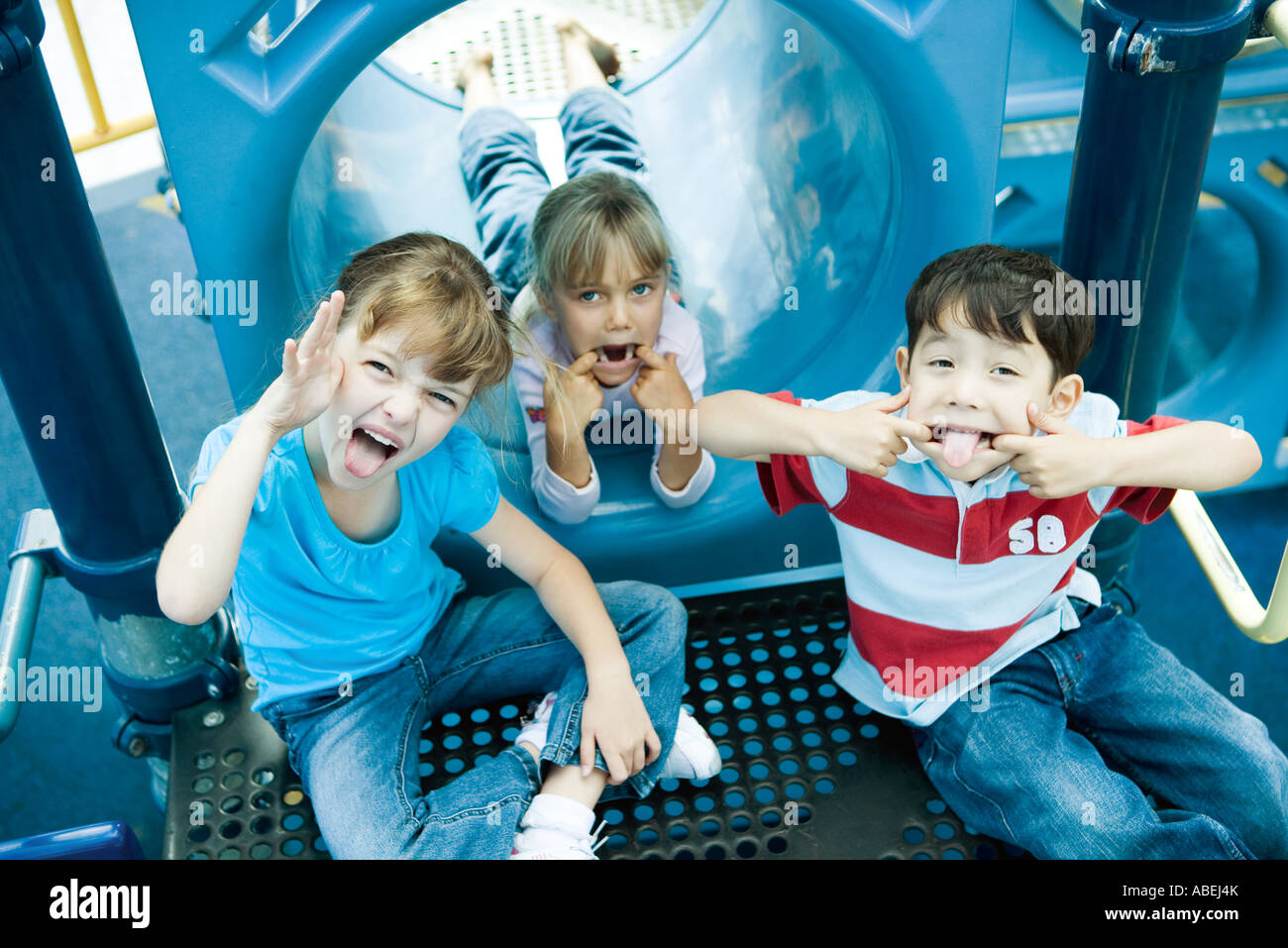 Children on playground equipment, making faces at camera Stock Photo ...