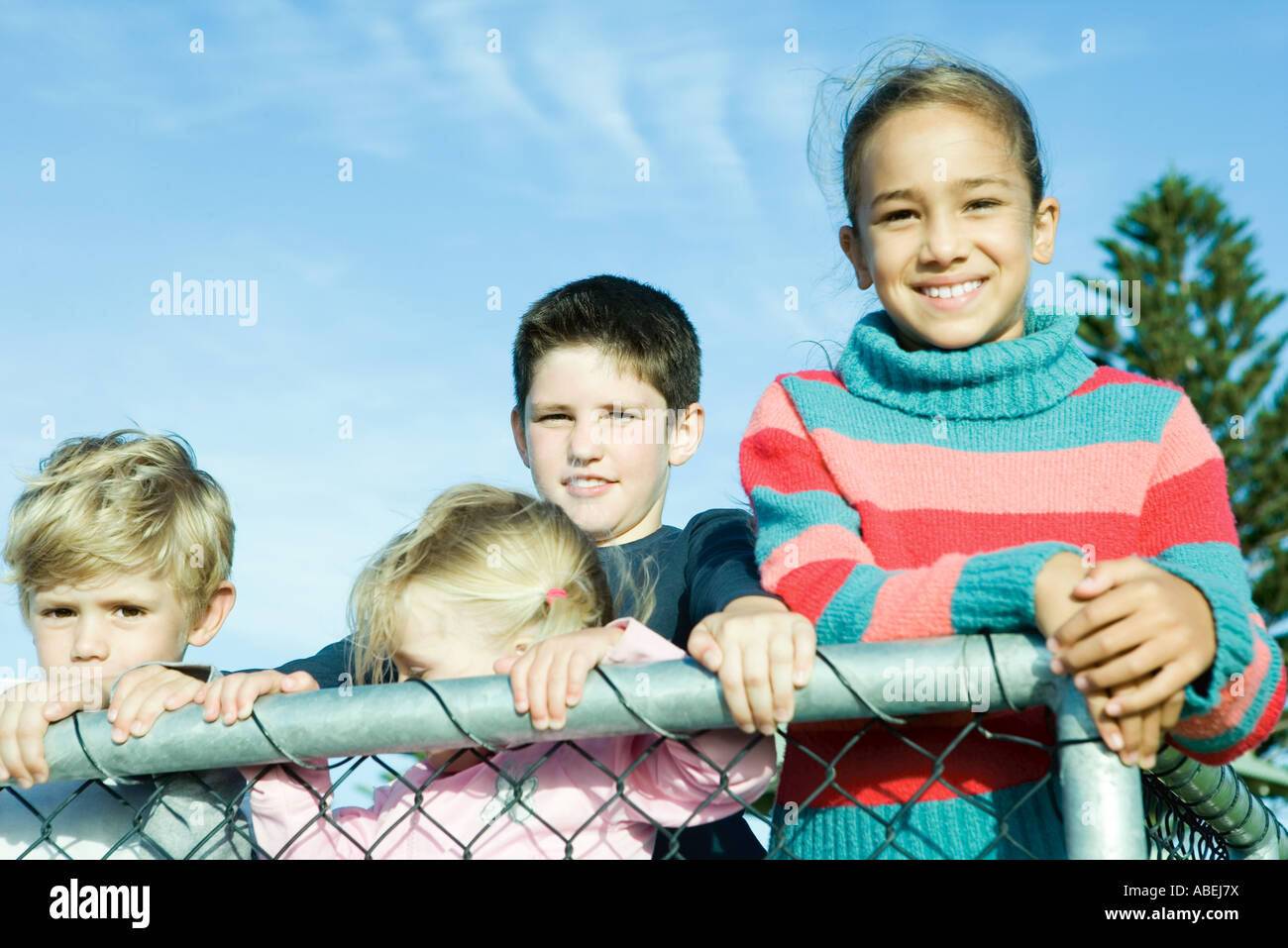 Group of people standing behind fence hi-res stock photography and ...