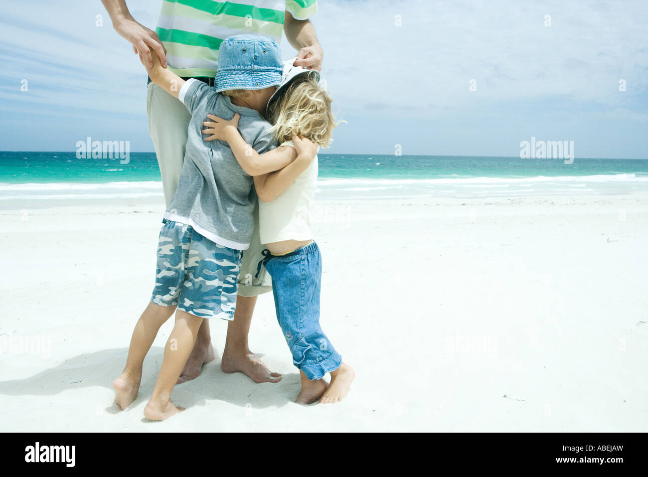 Rear view of parents hugging child hi-res stock photography and images ...