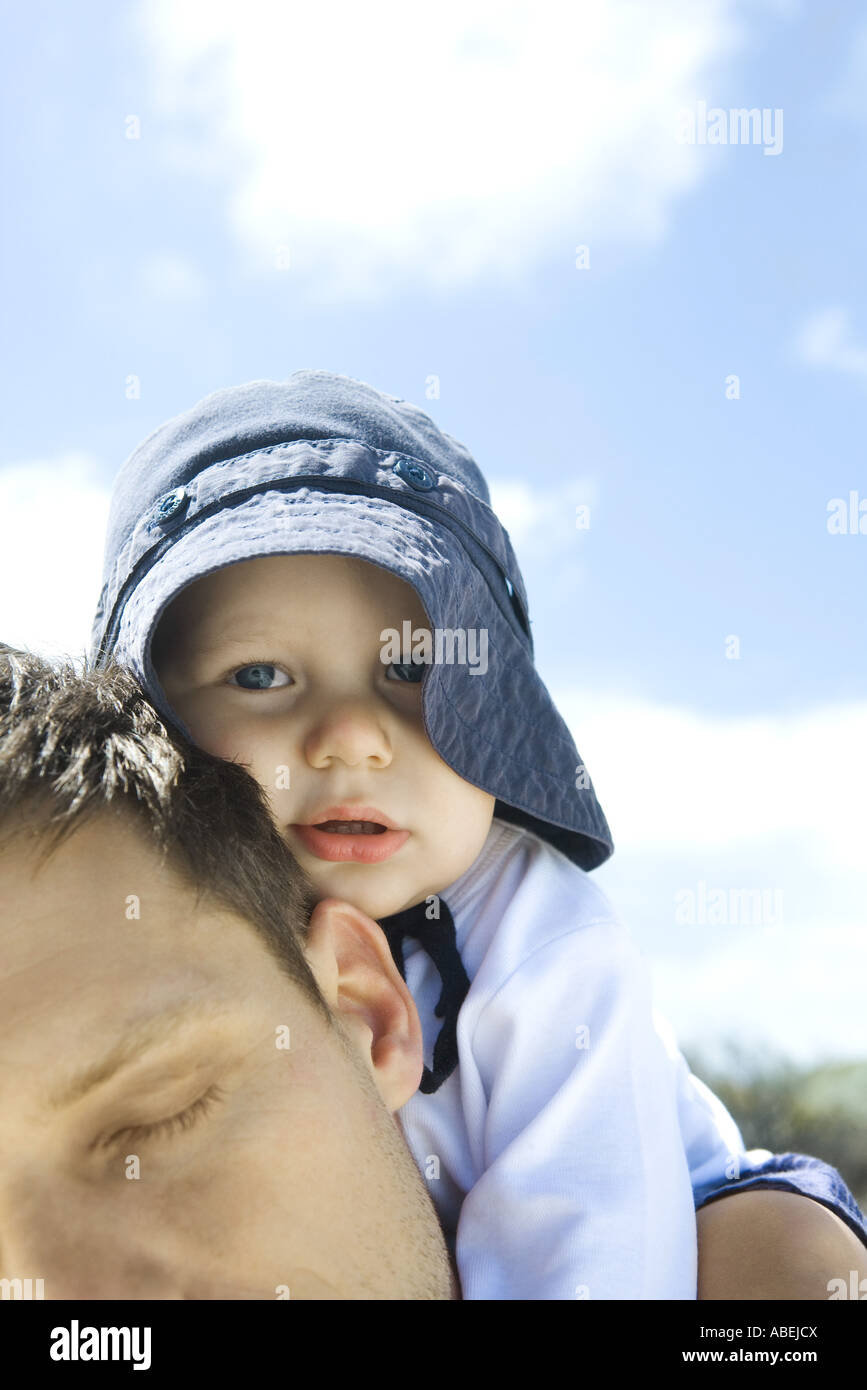 Man carrying baby on shoulders, cropped view Stock Photo - Alamy
