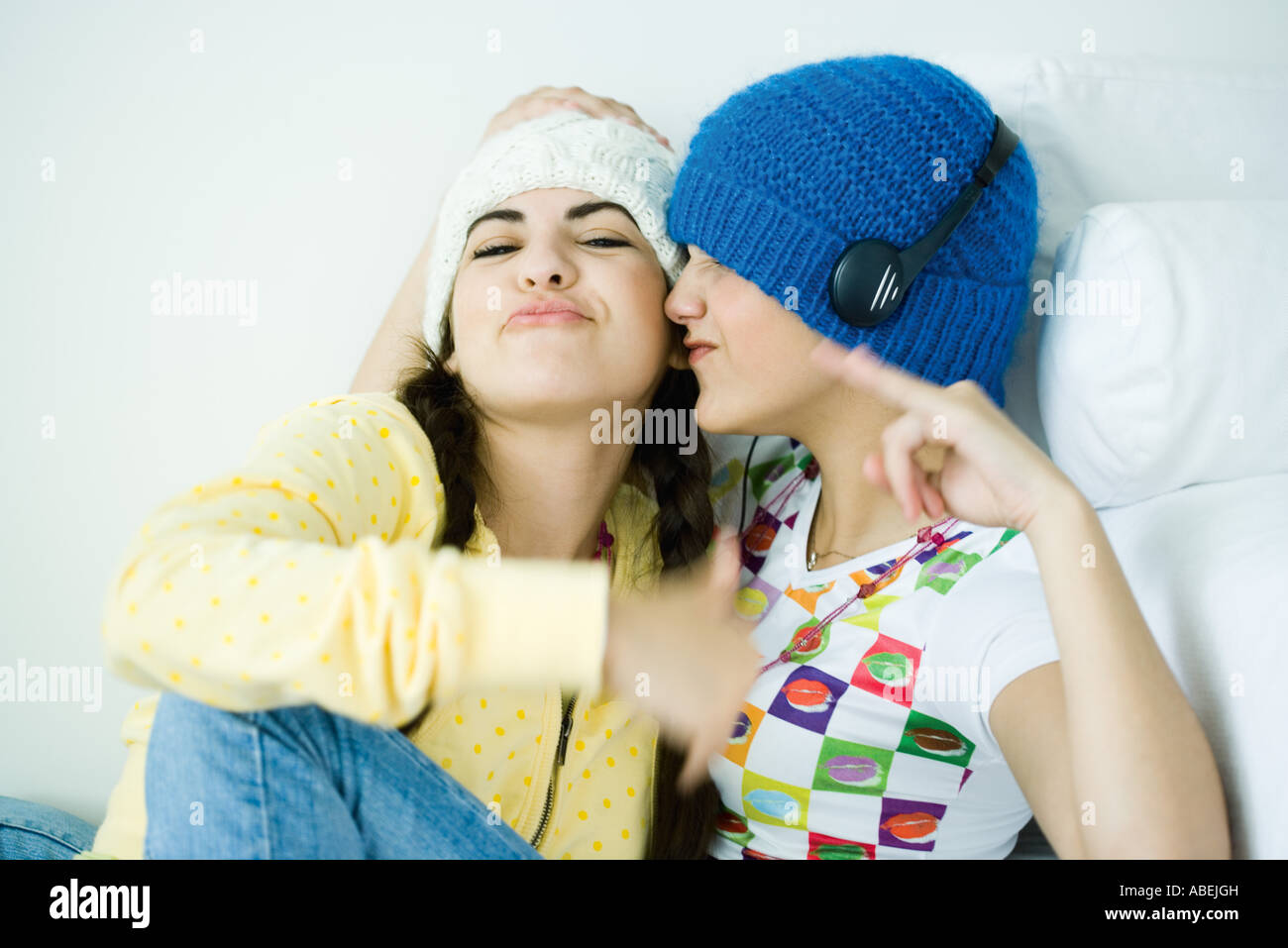 Two young female friends listening to music Stock Photo - Alamy