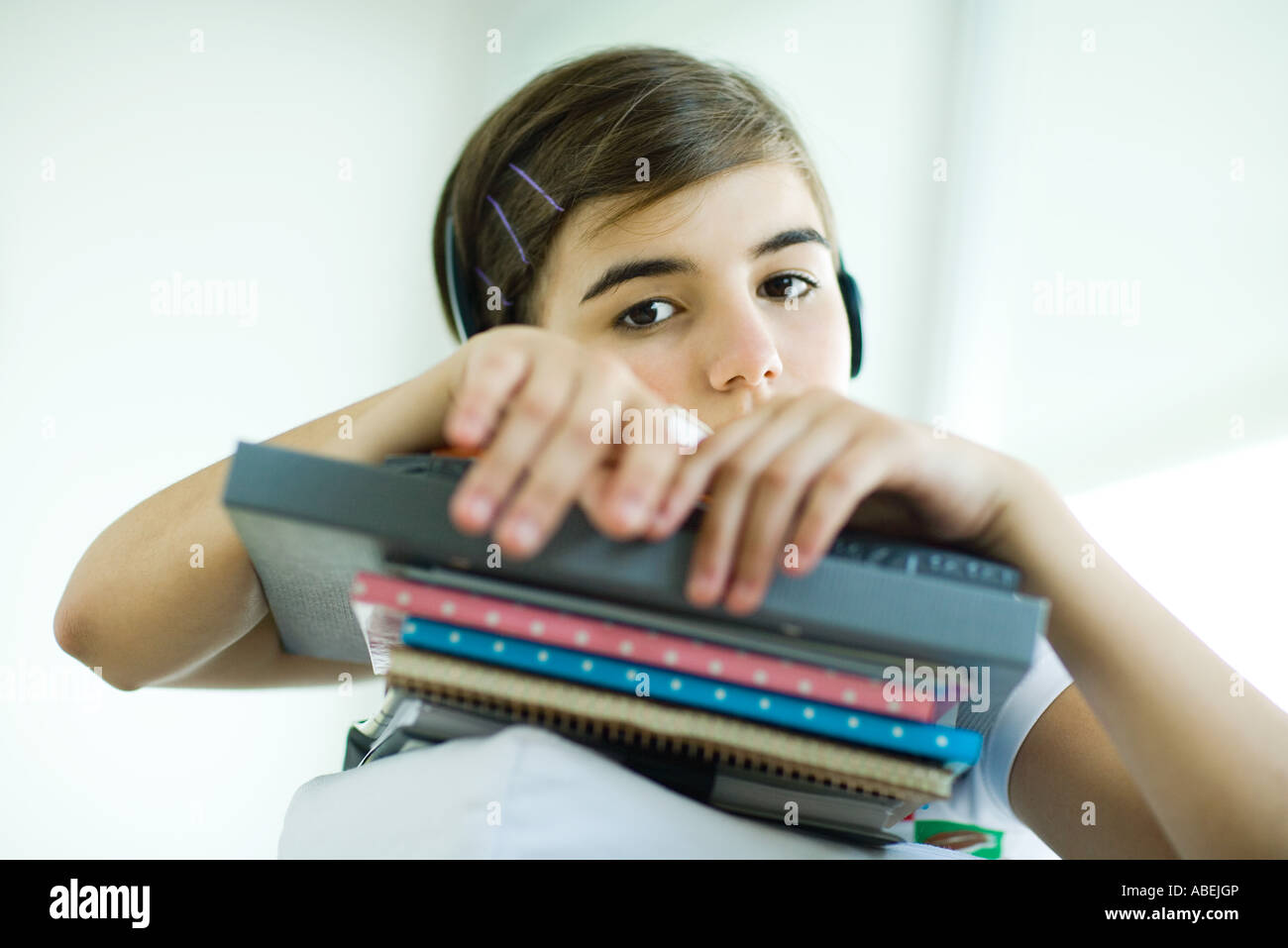 Teen girl holding stack of books and notebooks Stock Photo - Alamy