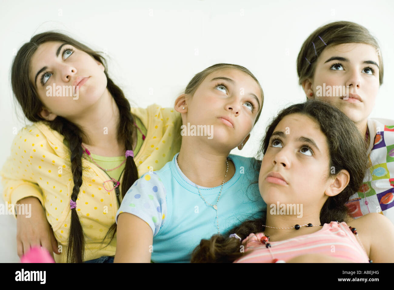 Four young female friends looking up Stock Photo - Alamy