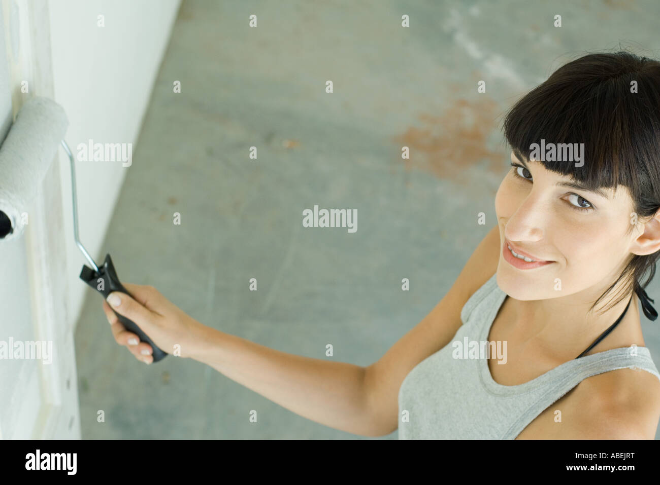 Woman painting with paint roller, high angle view Stock Photo - Alamy