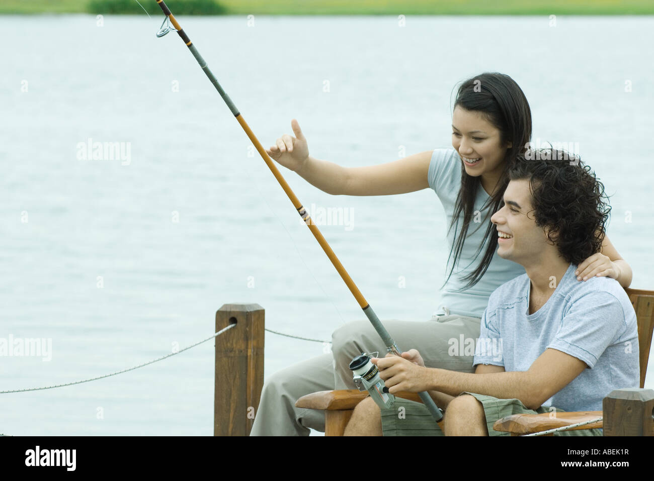Couple fishing on pier Stock Photo - Alamy