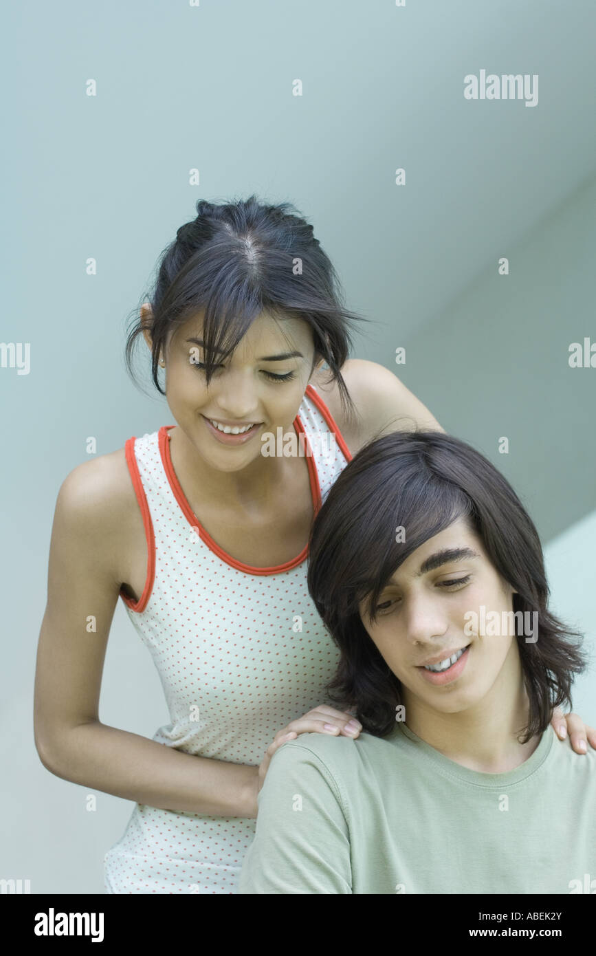 Young couple, woman looking over boyfriend's shoulder Stock Photo - Alamy