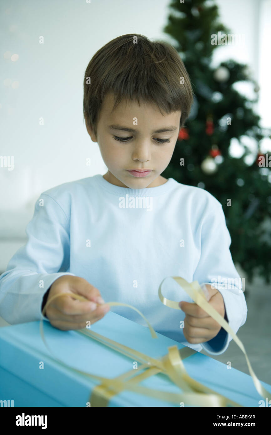 Boy opening Christmas present Stock Photo - Alamy