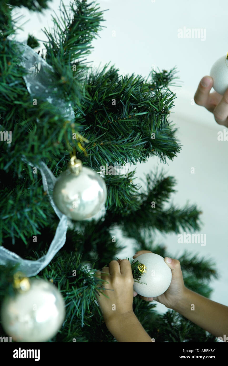 Unrecognizable person decorating christmas tree hi-res stock ...