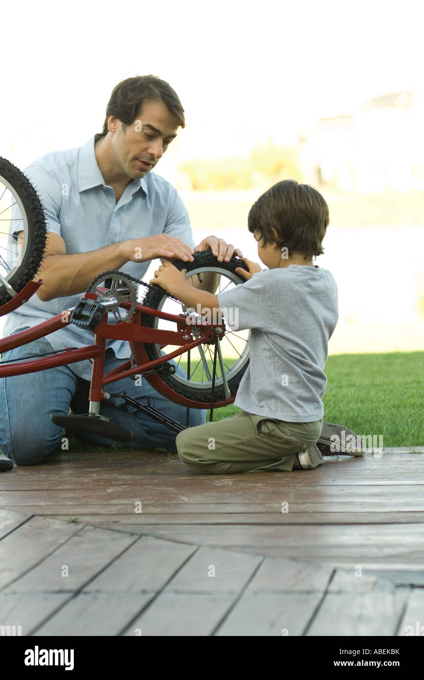 Father and son fixing bike together Stock Photo - Alamy