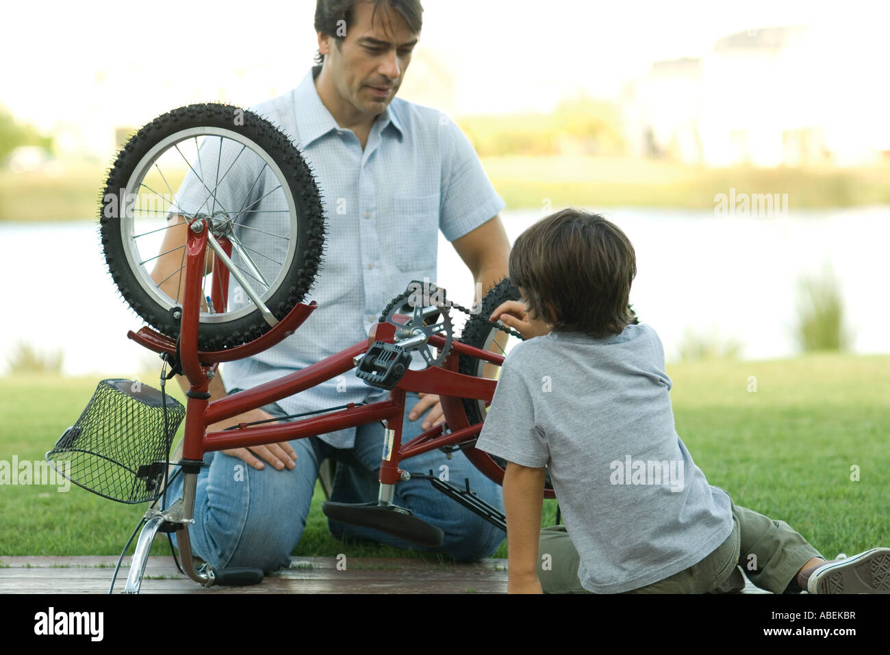 Father and son fixing bike together Stock Photo - Alamy