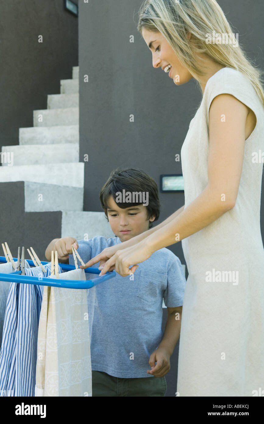 Mother and son hanging out laundry to dry Stock Photo - Alamy