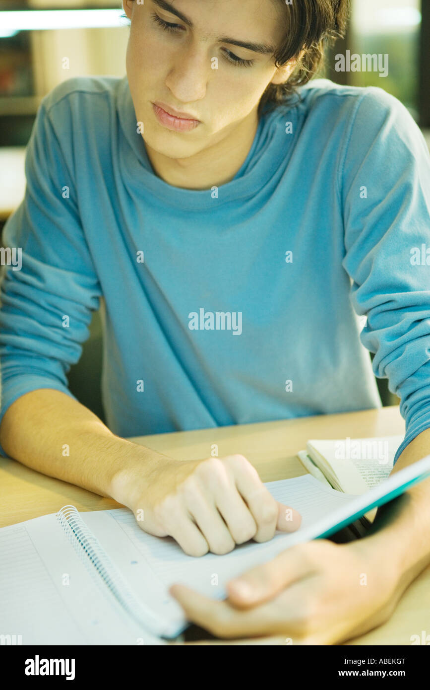 Male college student sitting in library, studying Stock Photo - Alamy