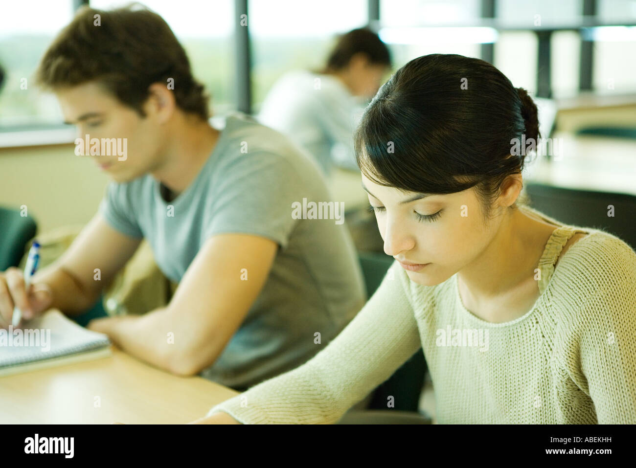 College students studying at tables in library Stock Photo - Alamy