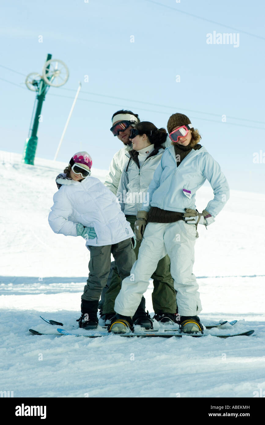 Young snowboarders standing on ski slope, full length portrait Stock ...