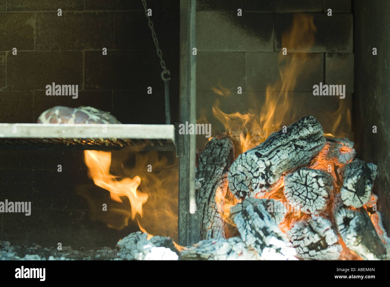 Meat grilling in wood oven Stock Photo - Alamy