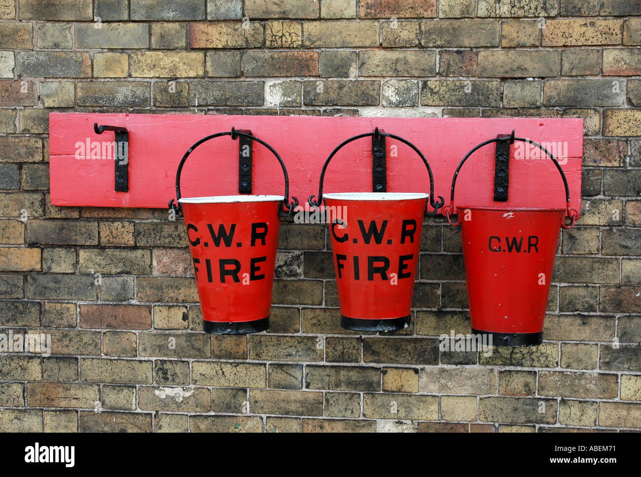 Row of red fire buckets Stock Photo - Alamy